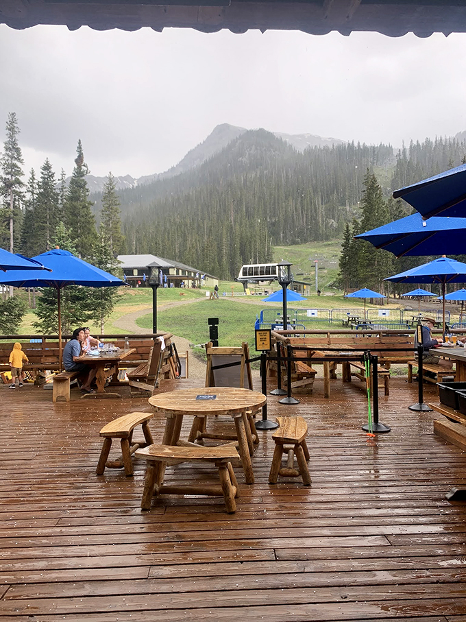 Rain or shine, the deck beckons with blue umbrellas and mountain views that make every bite taste just a little bit better.