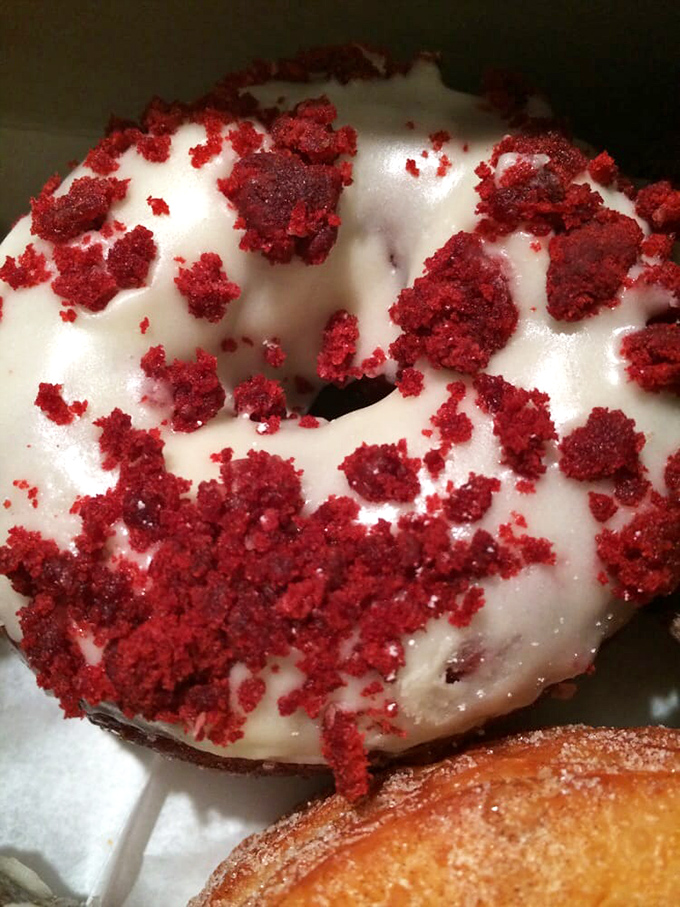 The red velvet donut &ndash; where cake meets donut in a crimson liaison. That cream cheese glaze isn't just topping; it's a commitment.