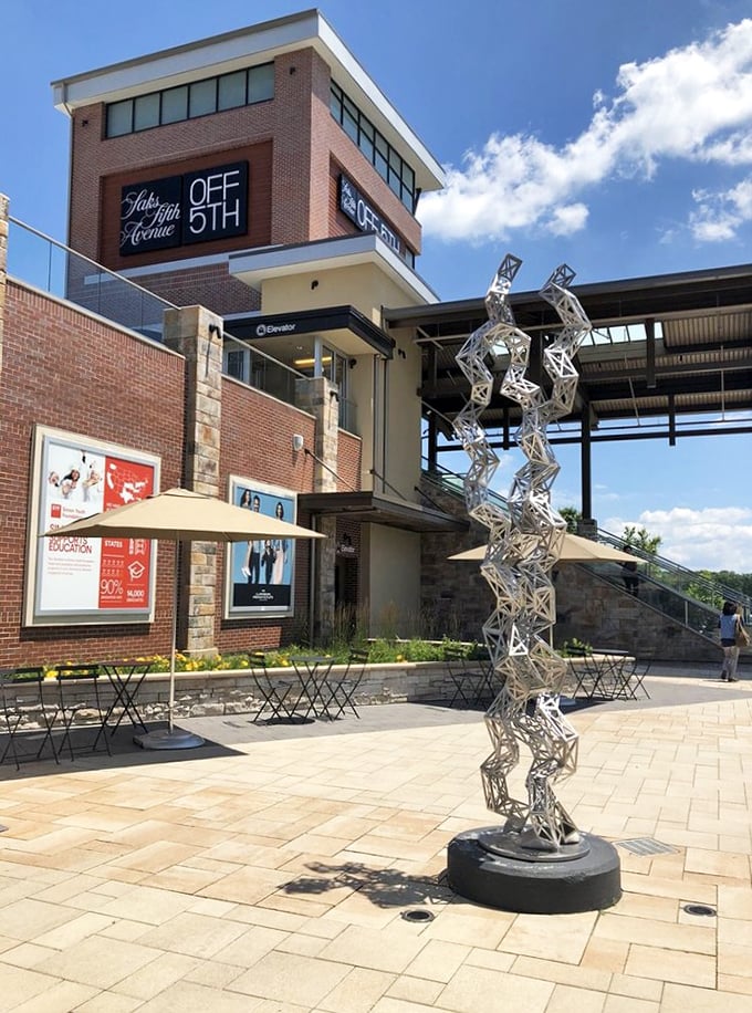 Art meets commerce at Saks OFF 5TH, where even the outdoor sculpture seems to be saying, "Yes, you deserve that cashmere sweater."