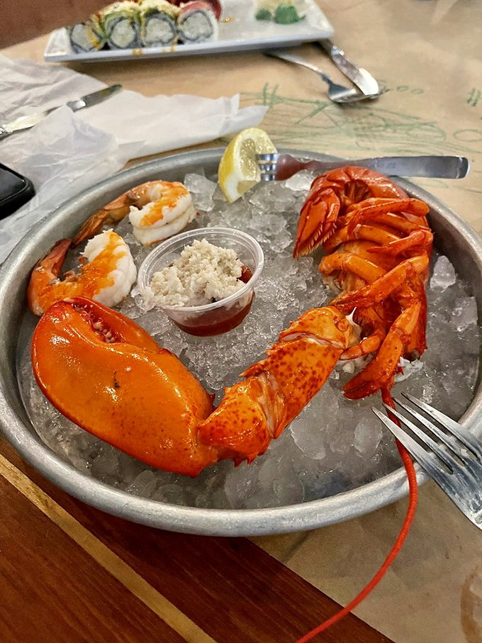 Ocean royalty on ice&mdash;lobster claw and shrimp holding court with cocktail sauce as their loyal subject.
