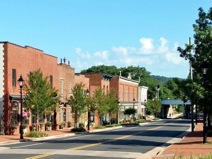 Historic brick storefronts and leafy green trees line the sunny, quiet main street while you explore the charming town of Gordonsville.