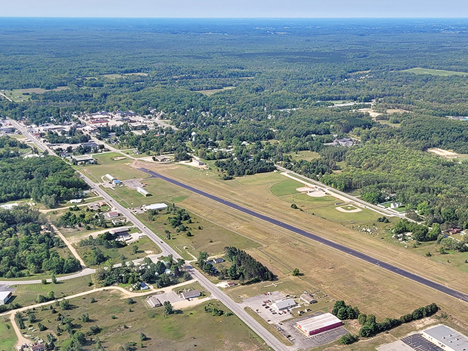 White Cloud's airport runway stretches across the landscape like nature's landing strip, surrounded by Michigan's endless forests.