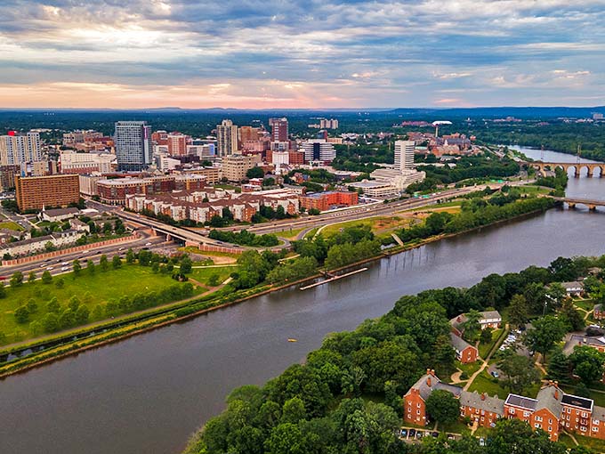 From above, New Brunswick's cityscape reveals the Raritan River winding alongside neighborhoods where fixed-income living remains possible in Central Jersey.