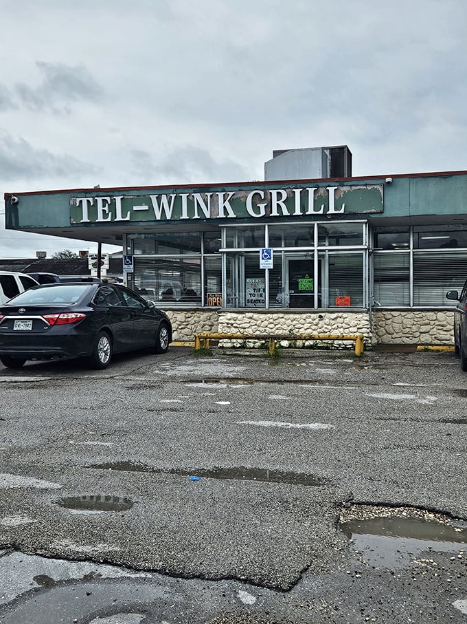 Puddles reflect Tel-Wink Grill's weathered sign - a reminder that breakfast spots with character have weathered many storms while keeping the griddle hot!