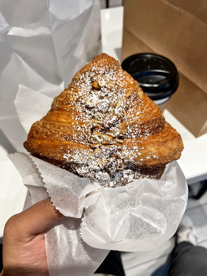 Powdered sugar cascades down buttery layers holding hidden treasures within—the pastry equivalent of opening the perfect gift.