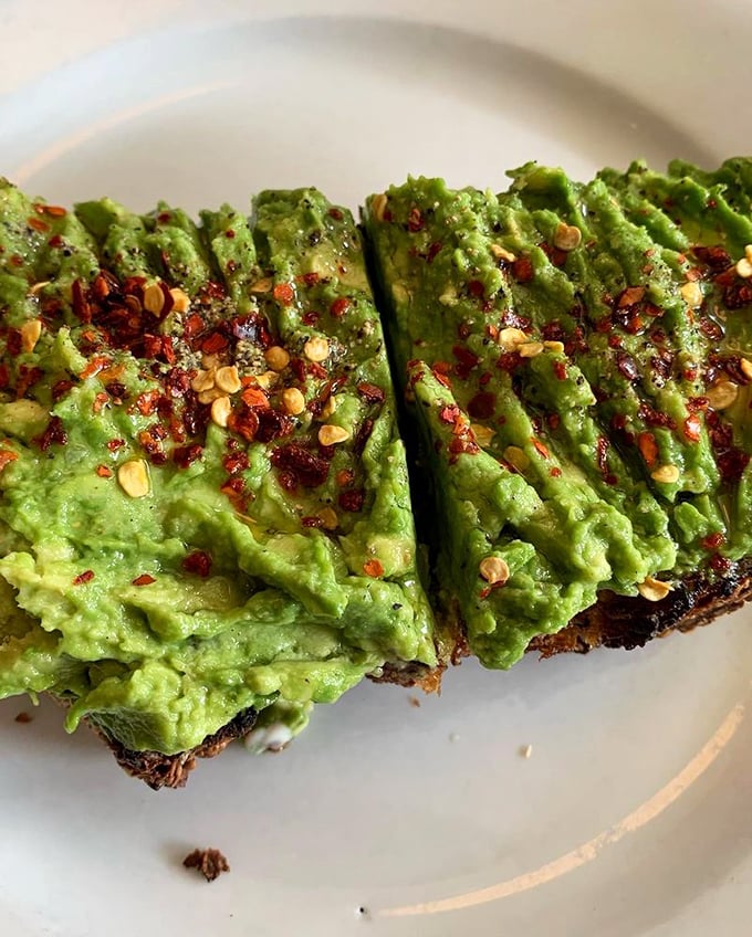 Avocado toast with red pepper flakes&mdash;California's contribution to breakfast culture, elevated to an art form worth every penny.