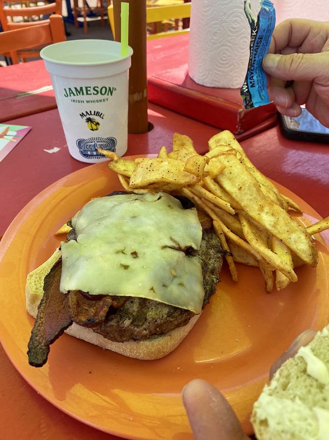 This burger isn't just wearing cheese&mdash;it's wrapped in a melty security blanket. Those seasoned fries look like they're trying to steal the show.
