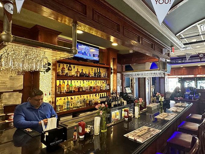 The bar gleams with promise, bottles standing at attention like soldiers ready to serve. Even teetotalers can appreciate this handsome display.