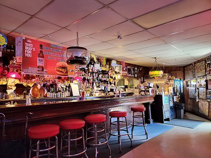 The bar itself&mdash;a shrine to simplicity where magic happens one cold beer and hot burger at a time. Those red stools have supported generations of happy diners.