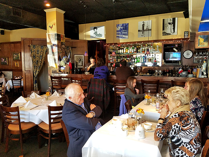 The bar area offers a front-row seat to the restaurant's warm hospitality, where regulars and first-timers alike are welcomed into the Caf&eacute; Provence family.