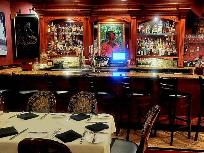 A bar stocked for serious business&mdash;whether you're a bourbon aficionado or just appreciate the warm glow of backlit bottles against rich wood.