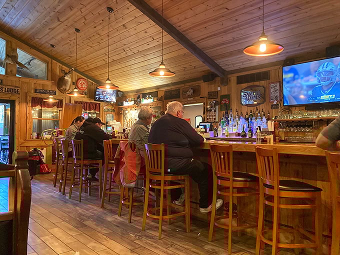 The bar where strangers become friends over bourbon and brisket discussions. Wood paneling never looked so inviting. 