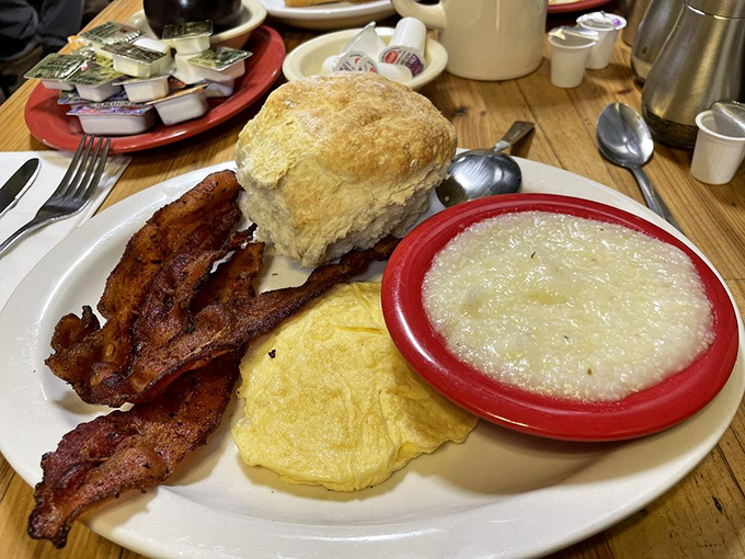 Breakfast diplomacy: eggs, bacon, grits, and a biscuit at peace on one plate – the morning summit meeting that always ends in agreement.