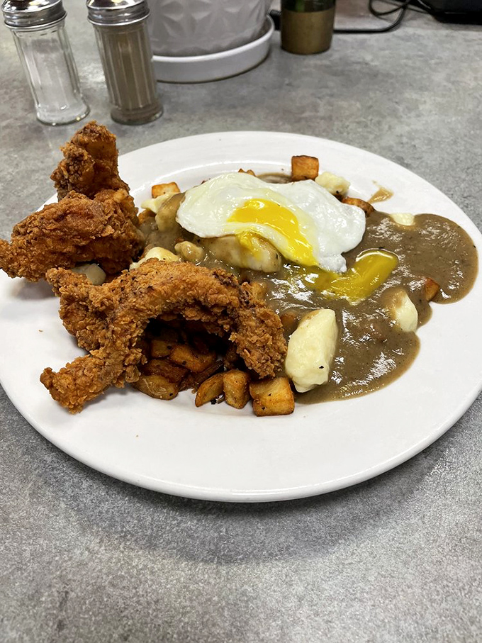 Comfort food gets an upgrade with this poutine-inspired creation where fried chicken and gravy turn breakfast into an event worth waking up for.