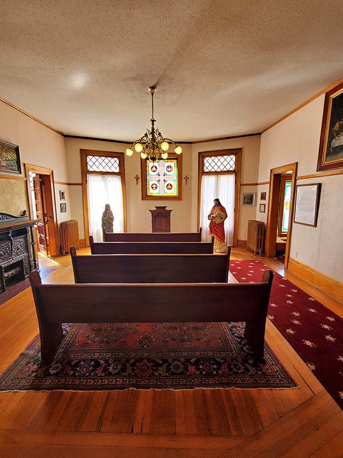 The castle's chapel offers a moment of quiet reflection, with simple wooden pews bathed in light from stained glass windows.