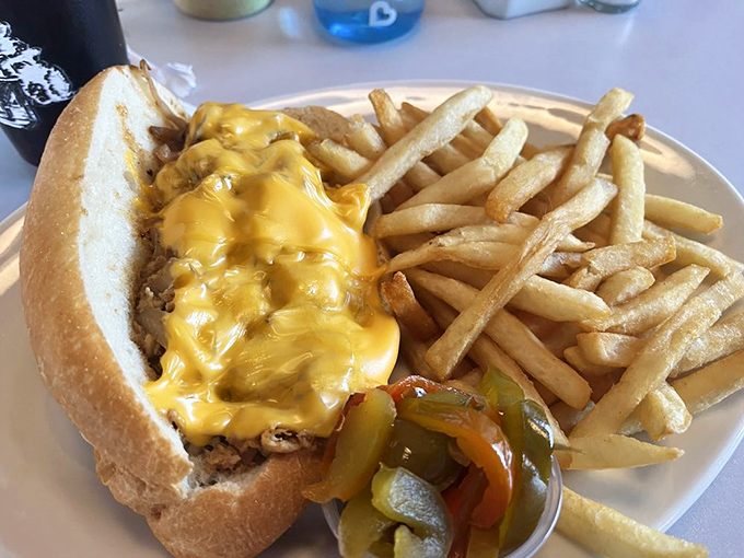 This chicken cheesesteak, smothered in molten cheese with pickles on standby, is the kind of sandwich that demands both hands and your full attention.