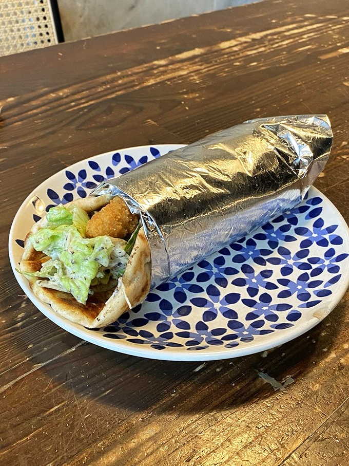 Wrapped like a present your taste buds can't wait to unwrap&mdash;this pita delivers plant-based satisfaction on a beautiful blue-patterned plate.