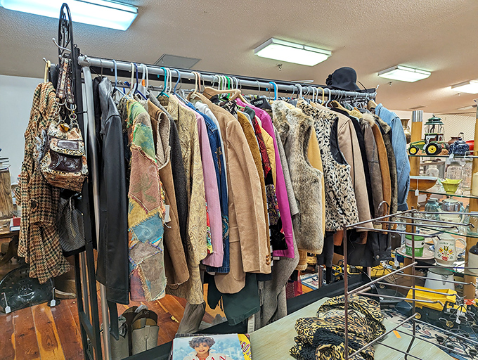 Vintage fashion hangs with patient dignity, waiting for new life. That leopard print coat has stories it's dying to tell.