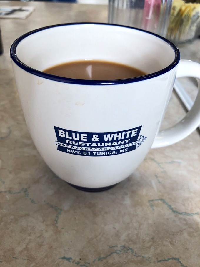 Their signature mug filled with coffee that's meant to be savored, not rushed. The blue rim matches the restaurant's soul&mdash;straightforward and welcoming.