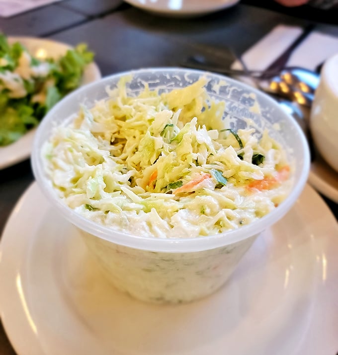 This isn't just coleslaw; it's the cool, crisp counterpoint that makes every bite of fried goodness even more magnificent.