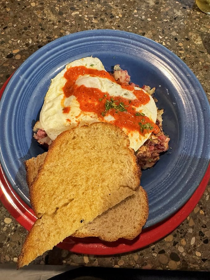 Eggs and corned beef hash on toast&mdash;the breakfast equivalent of a warm hug from someone who really gets you.