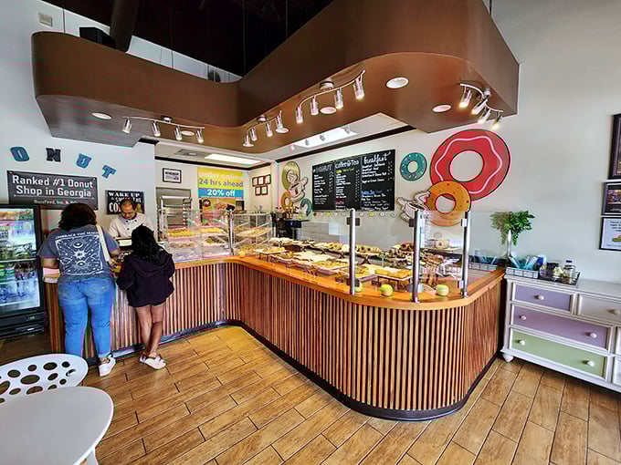 The counter curves like a question mark, inviting your indecision. Behind that glass lies a universe of possibilities, each more tempting than the last.