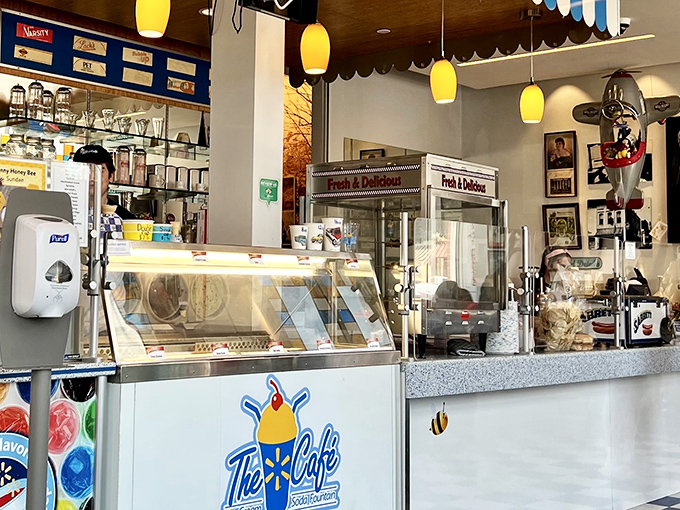 Behind this counter, magic happens. The gleaming display cases and vintage-inspired signage promise confections worth the inevitable brain freeze.