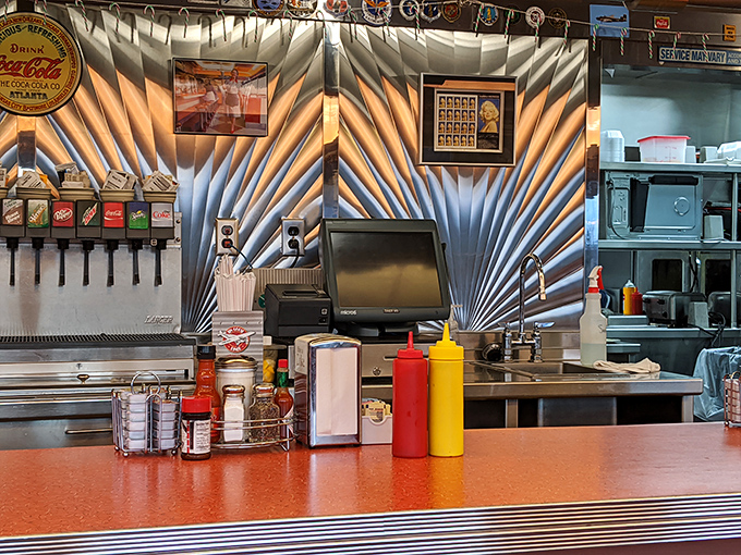 Where the magic happens. The stainless steel backdrop and classic condiment bottles create the perfect stage for diner theater.