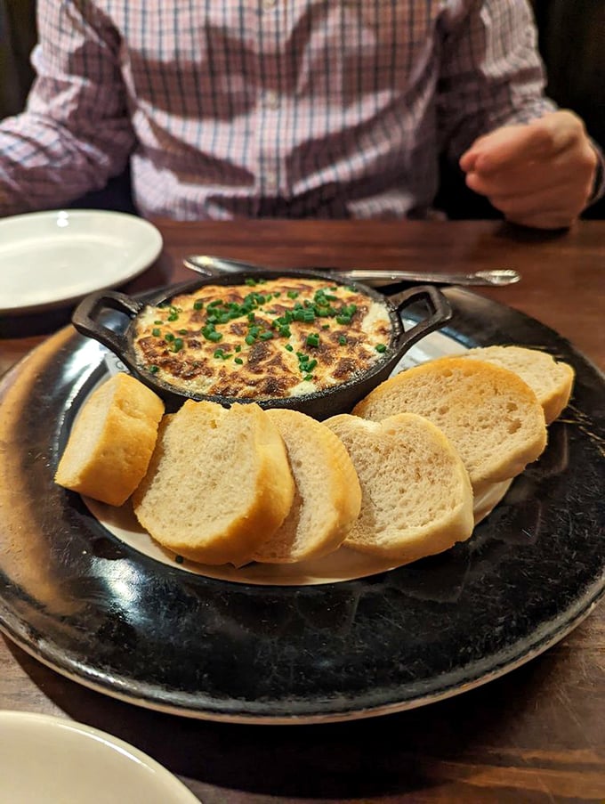 The crab and artichoke dip arrives with a bread entourage, creating that perfect moment when "sharing" becomes a theoretical concept rather than actual practice.