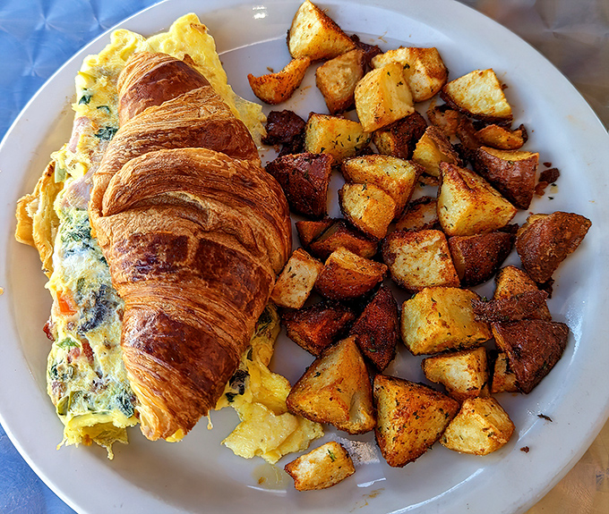 This croissant omelet with perfectly seasoned home fries is what breakfast dreams are made of&mdash;flaky, fluffy, and fantastically satisfying.