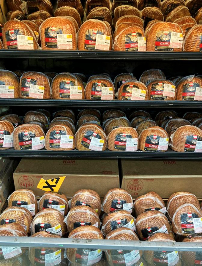 Spiral-cut hams stacked like edible treasures&mdash;holiday dinner centerpieces without the holiday-sized price tags.