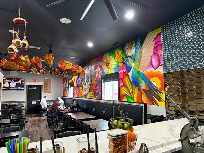 The vibrant mural featuring hummingbirds and flowers isn't just wall decor&mdash;it's a visual mariachi band serenading your meal with color.