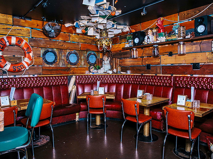 The wooden walls and porthole windows create the perfect illusion of dining inside a well-appointed submarine captained by Wes Anderson.