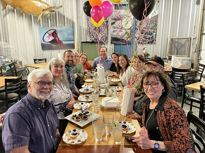 Happy diners celebrating with oysters and smiles. Nothing brings people together like seafood that's worth the journey.