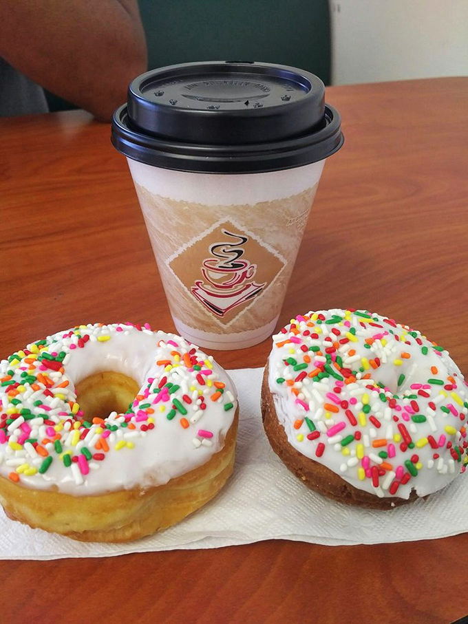 The perfect morning duo: steaming coffee paired with sprinkle-topped donuts—a combination that has launched countless productive workdays and weekend adventures.