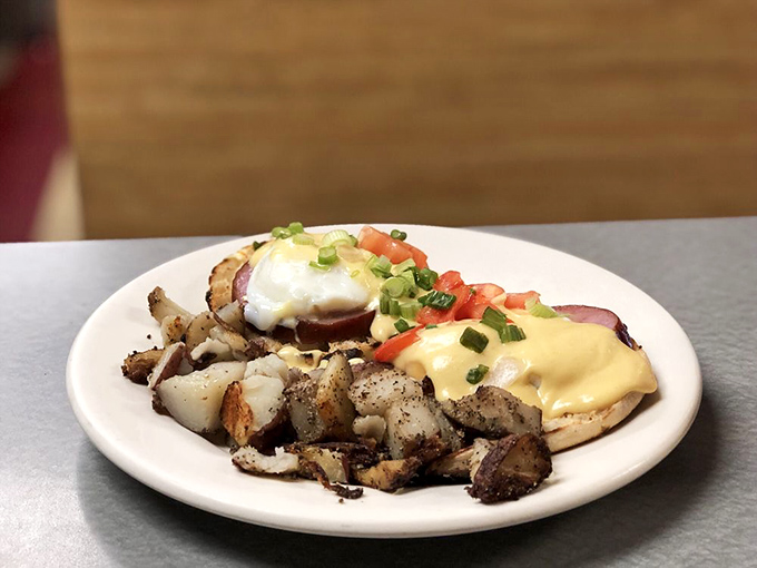 Hollandaise sauce cascading over eggs Benedict like a yellow waterfall of breakfast dreams. The kind of dish worth setting your alarm for.