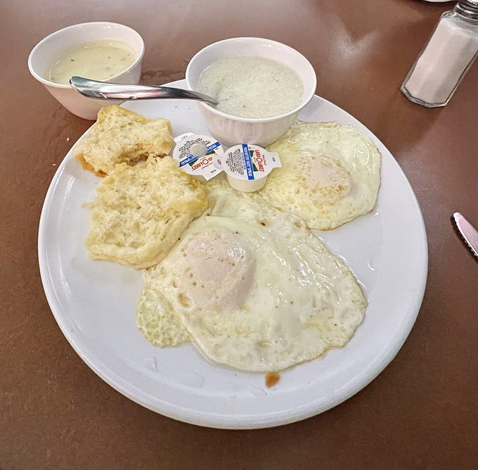 Simple pleasures done right: perfectly cooked eggs, biscuit, and creamy sides that remind you why breakfast will always be the superior meal.