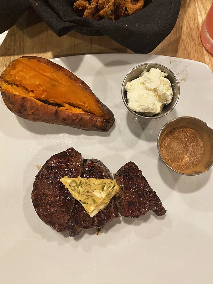 That sweet potato glows with the same orange intensity as autumn in the mountains, while the filet whispers promises of buttery tenderness.