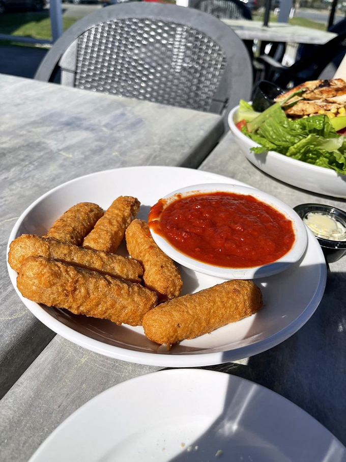 Fried mozzarella sticks: proof that the simplest pleasures are often the most profound, especially when dunked in that vibrant marinara.