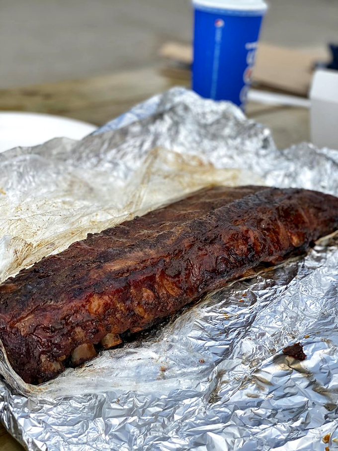 The full rack unwrapped is like opening a present&mdash;spice-crusted ribs with that perfect bend that says "we're done exactly right."