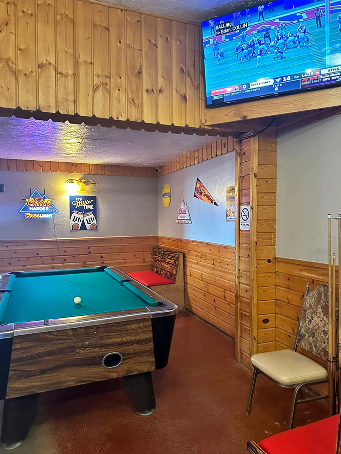 The game room where calories don't count and pool sharks swim alongside sports fans. Beer signs glow like beacons of hospitality.