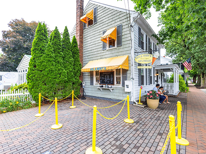 Gil & Bert's Ice Cream Shop, with its cheerful awnings and brick walkway, stands ready to solve problems one scoop at a time.