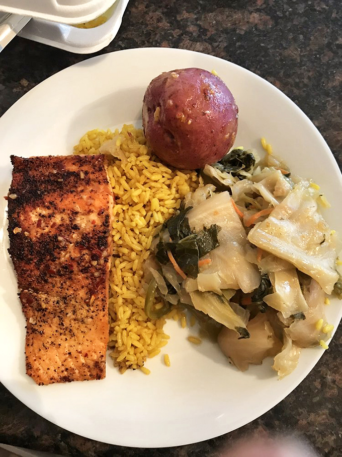 Blackened salmon, yellow rice, and perfectly cooked greens. Soul food that nourishes both body and spirit.