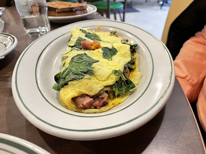 An omelet that's not afraid to show its true colors. The spinach and ham are having a party, and everyone's invited.