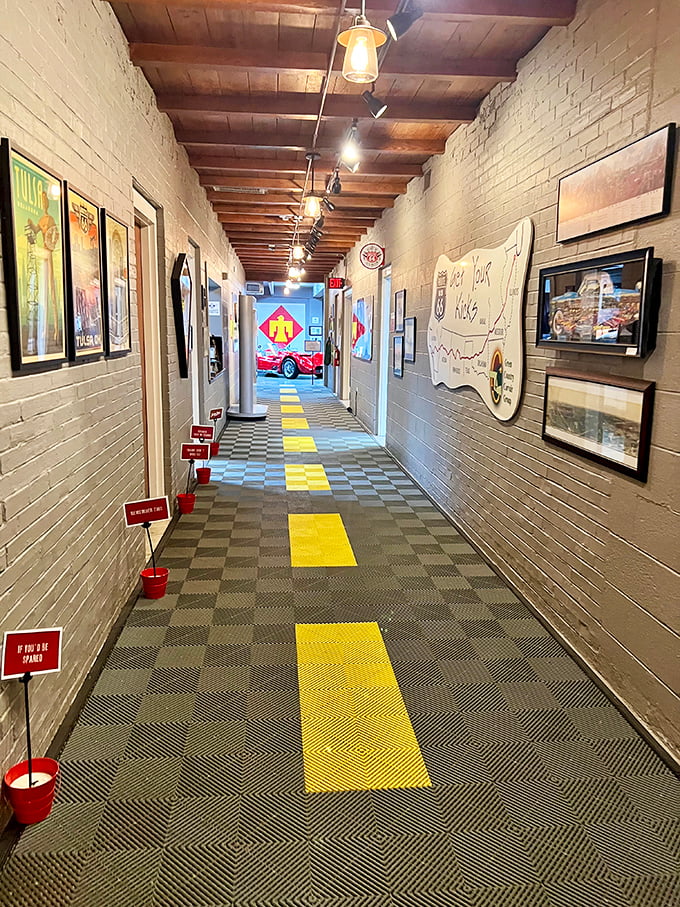 The museum's hallway mimics Route 66 itself, with yellow road stripes guiding visitors through a journey of automotive nostalgia and discovery.