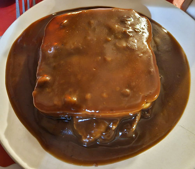 The hot roast beef sandwich doesn't just come with gravy – it practically bathes in it, like a spa treatment for comfort food.