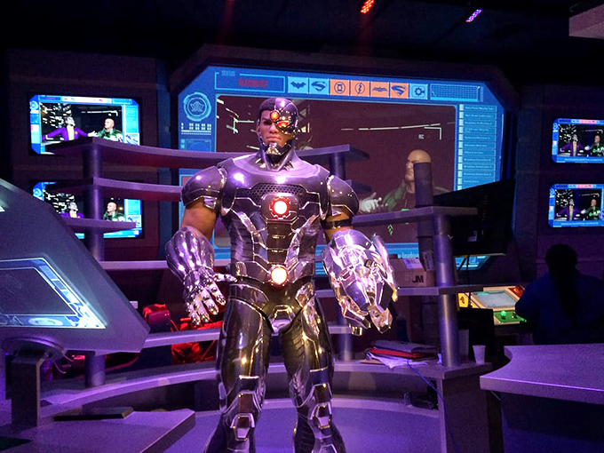 In the Justice League attraction, superhero statues stand ready to assist visitors whose courage mysteriously disappeared at the ride entrance.
