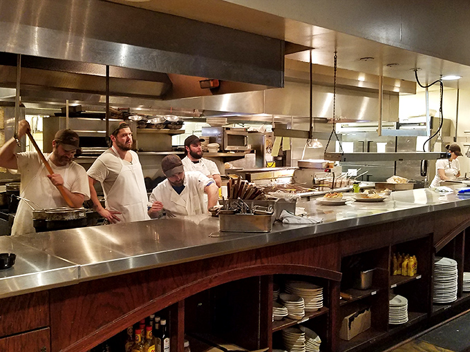 Where the magic happens! The open kitchen reveals the choreographed dance of chefs transforming fresh ingredients into memorable meals.