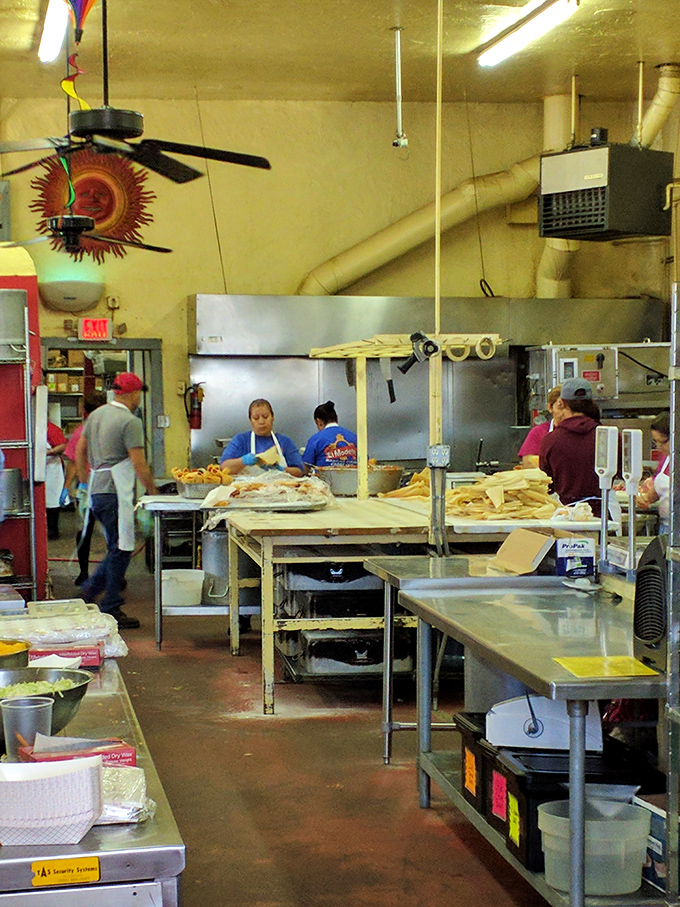 The kitchen reveals the beating heart of El Modelo—skilled hands preparing masa treasures with the precision that only comes from years of practice.