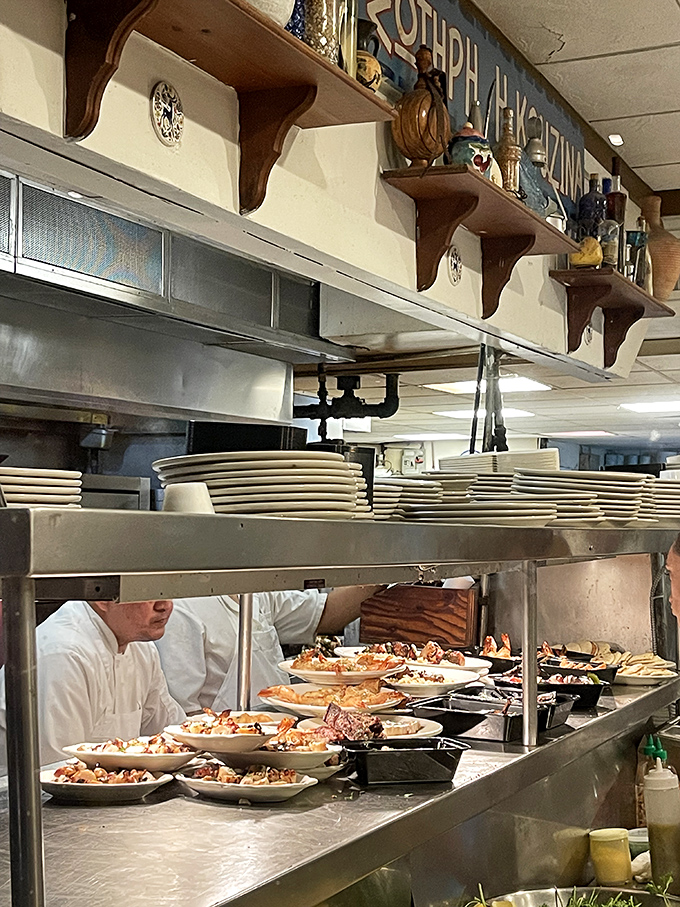 Behind every great Greek meal is a kitchen where plates line up like soldiers awaiting deployment. Culinary choreography at its finest.